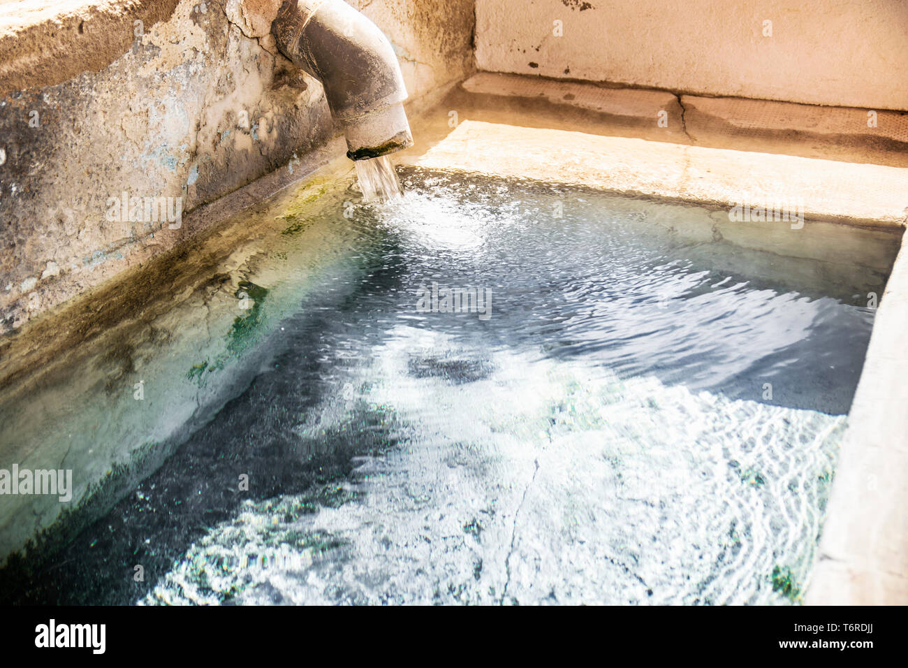 Thermal water fountain next to a spa and relaxing bath. Thermalism and ...