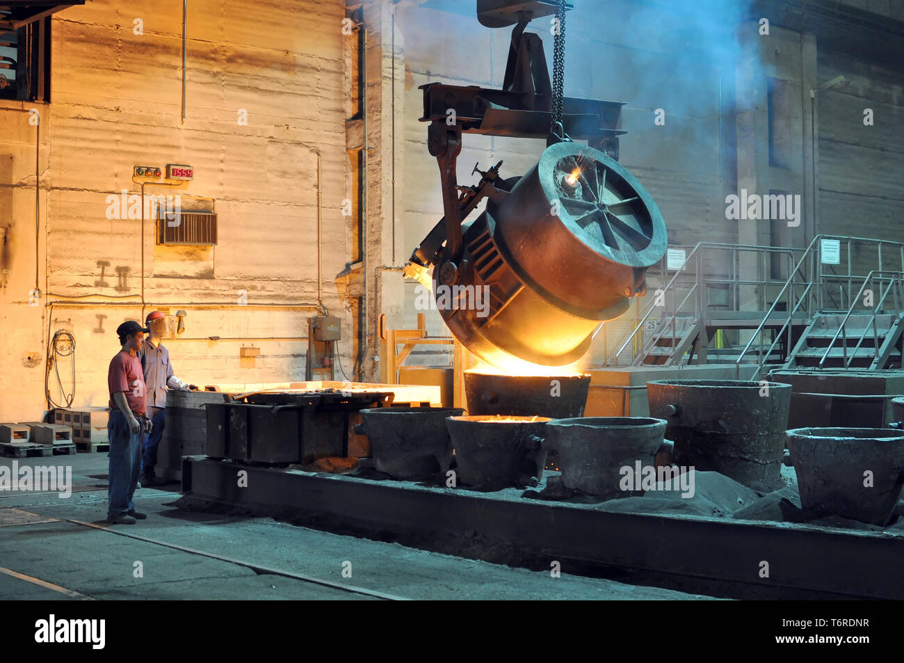 Production of metal components in a foundry - group of workers Stock ...