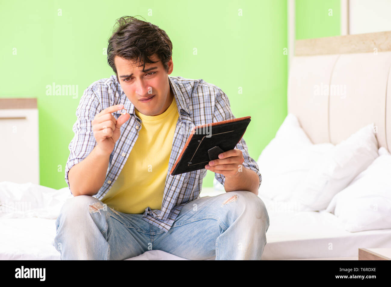 Young man sad in unhappy love concept Stock Photo - Alamy