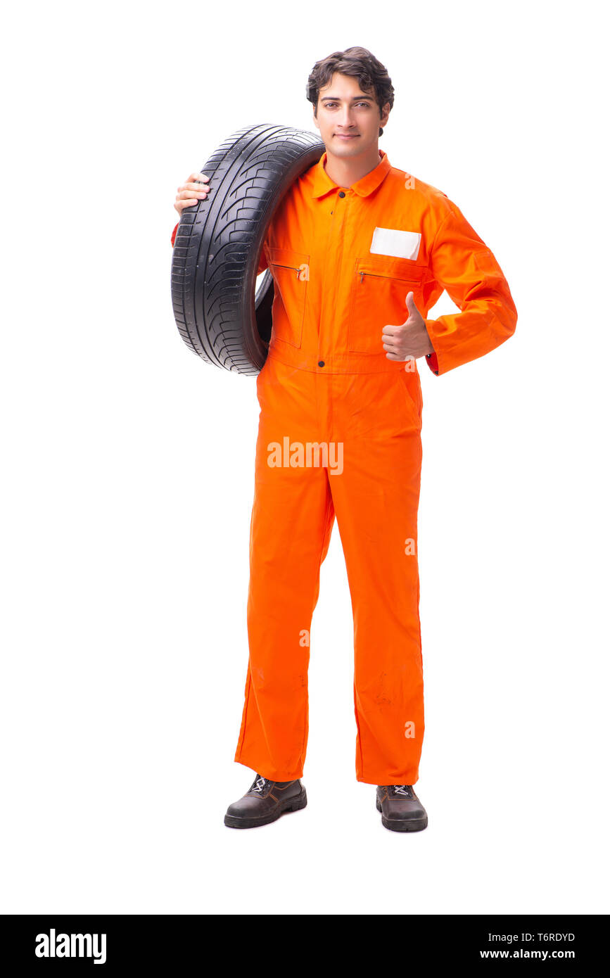 Young garage worker with tyre isolated on white Stock Photo - Alamy