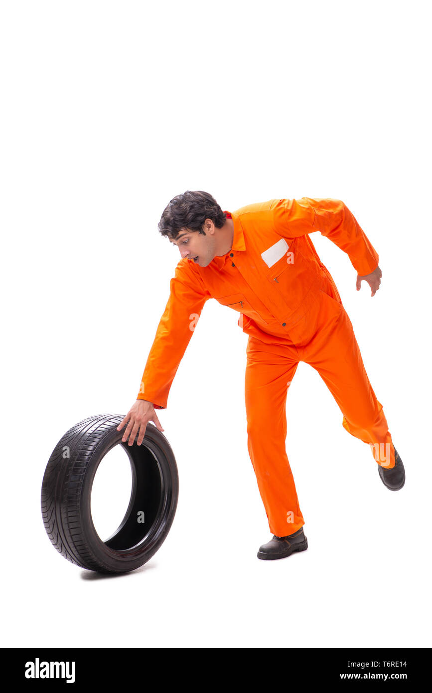 Young garage worker with tyre isolated on white Stock Photo - Alamy