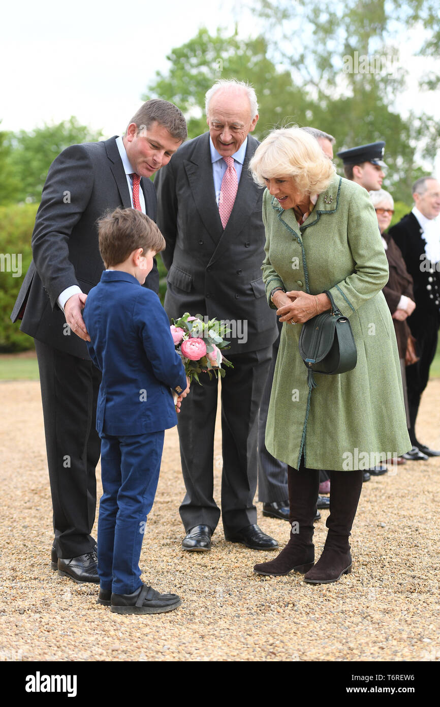 The Duchess of Cornwall is presented with a posie by Archie Lane, son ...
