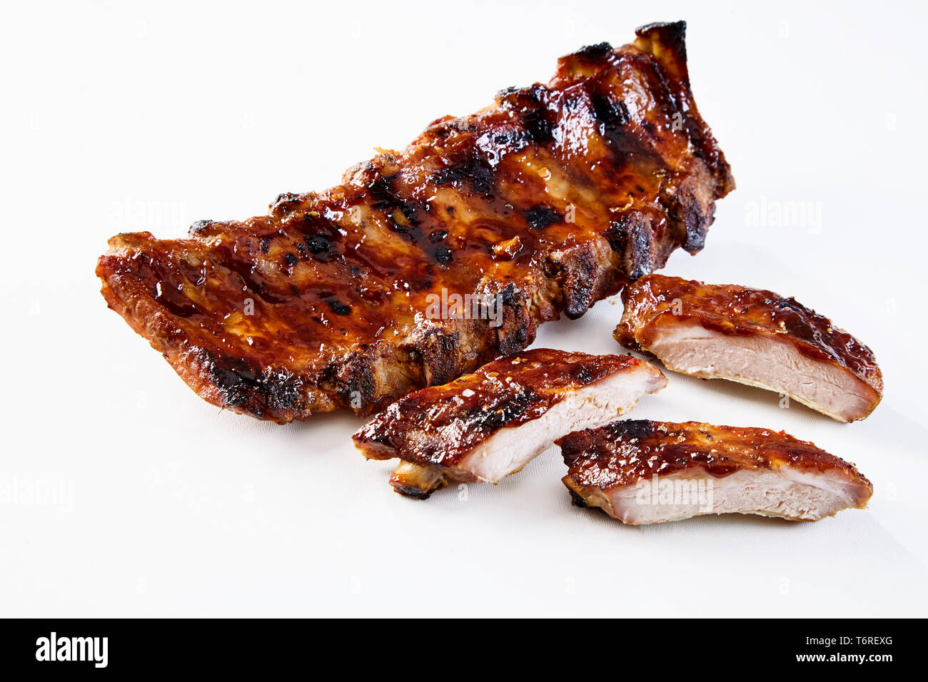 Barbecued and marinated sticky spare ribs on a white background with ...