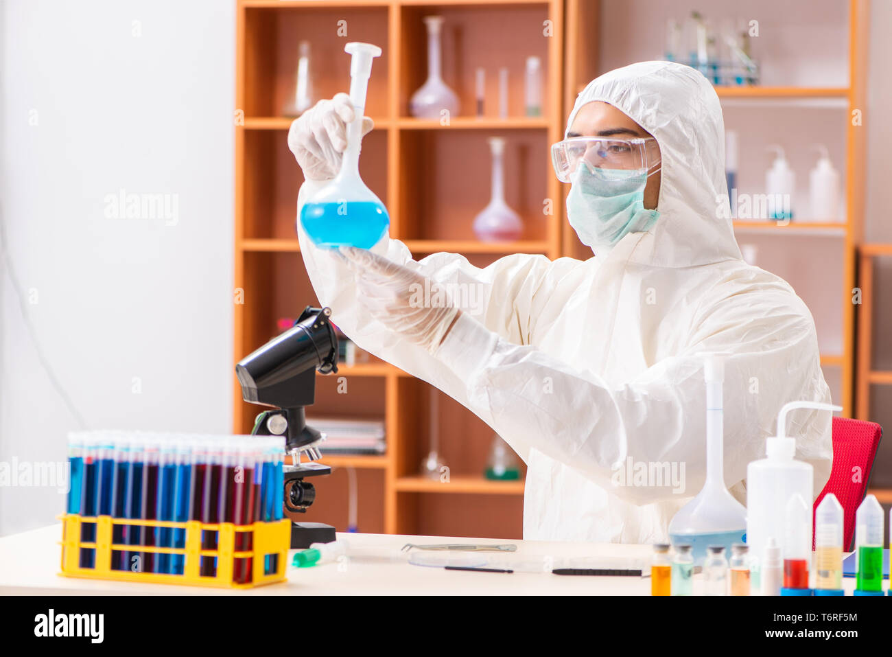 Young biochemist wearing protective suit working in the lab Stock Photo ...