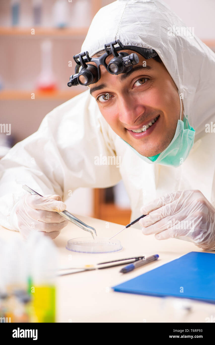 Young biochemist wearing protective suit working in the lab Stock Photo ...