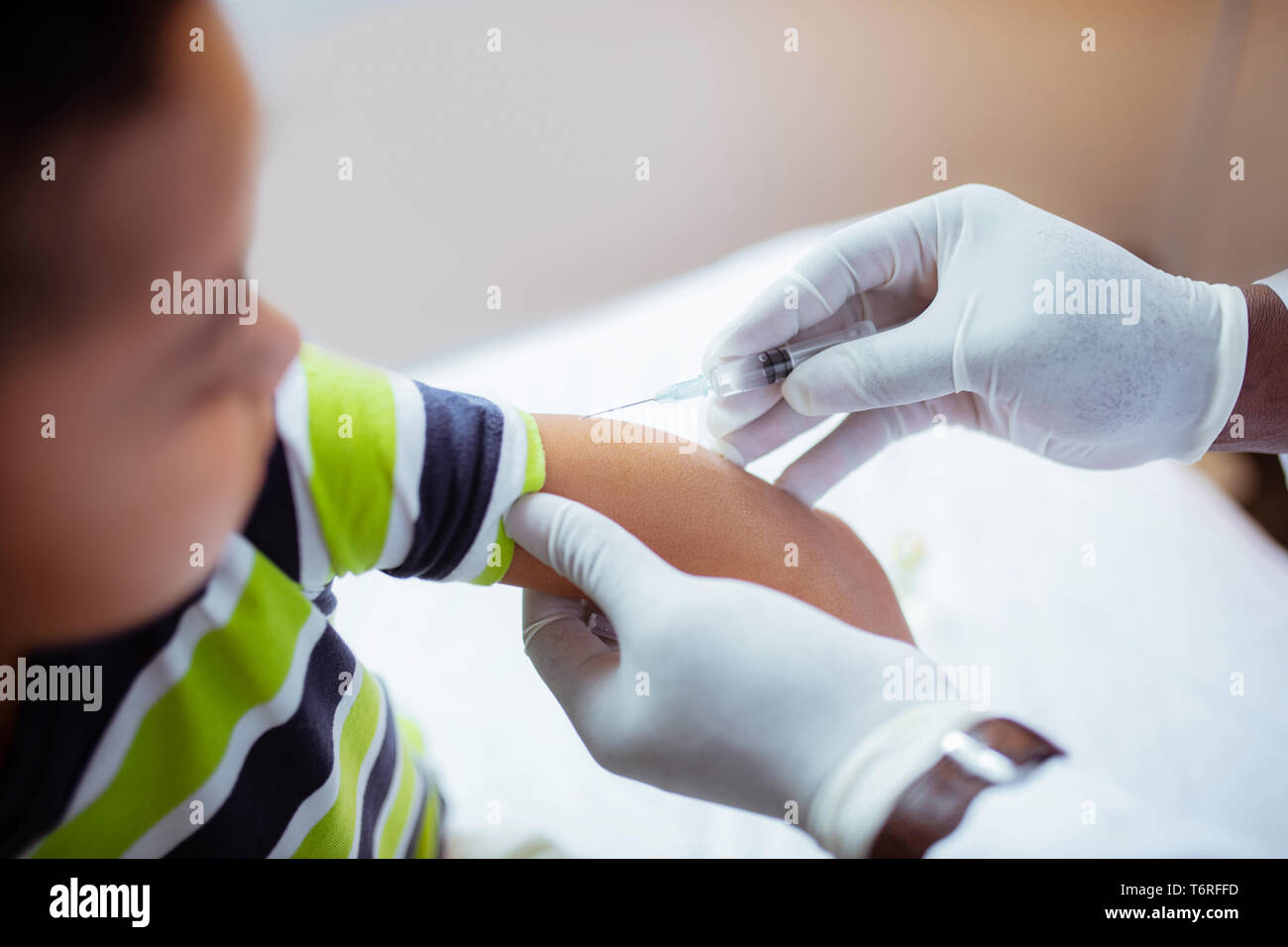 Close up of pediatrician wearing white gloves making injection Stock ...