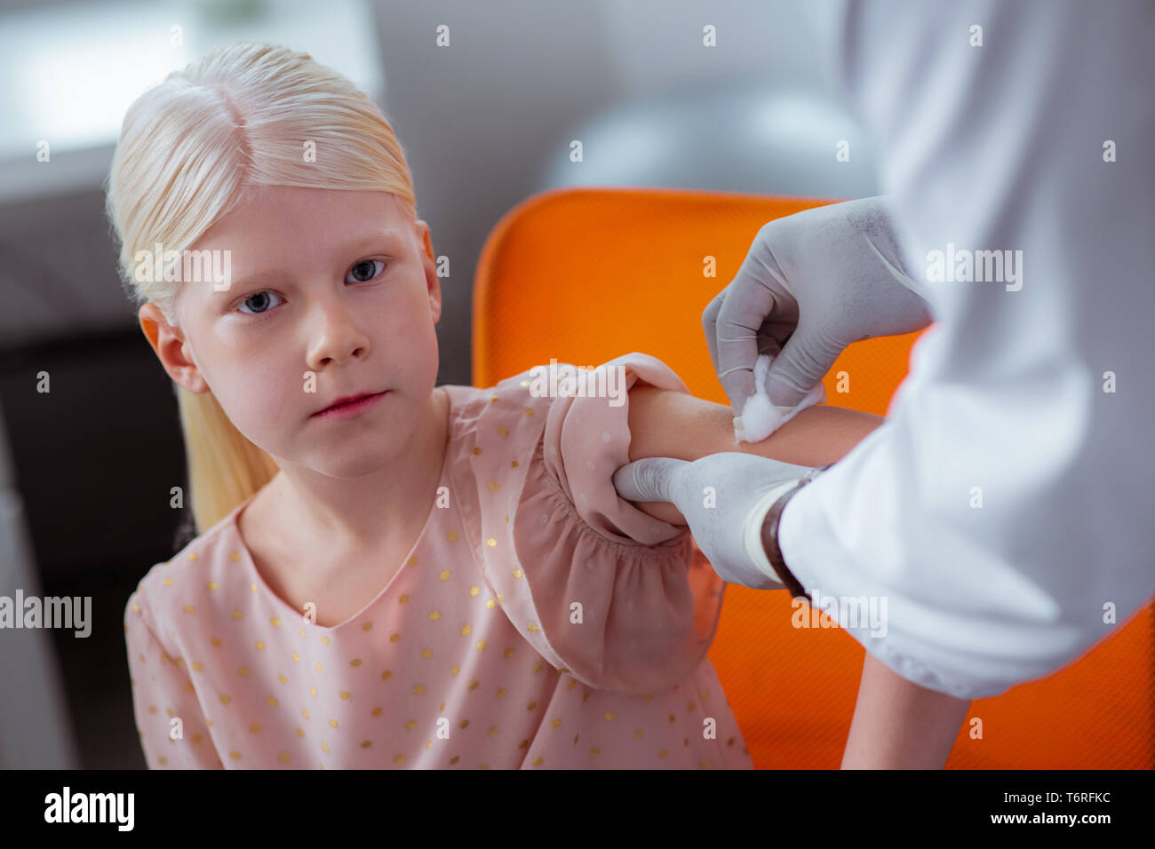 Beautiful blonde girl feeling calm while getting injection Stock Photo ...