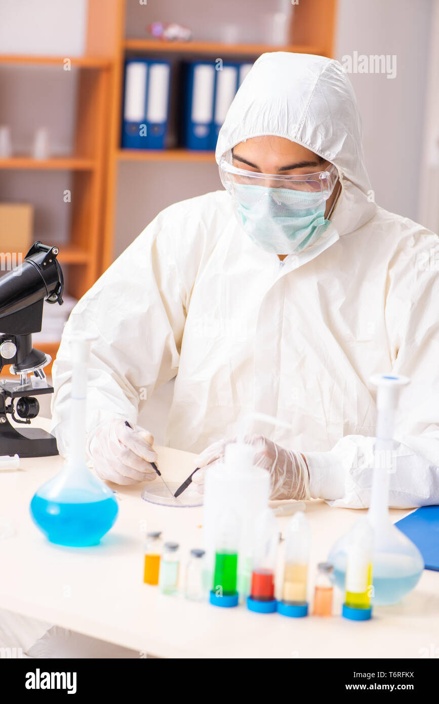 Young biochemist wearing protective suit working in the lab Stock Photo ...