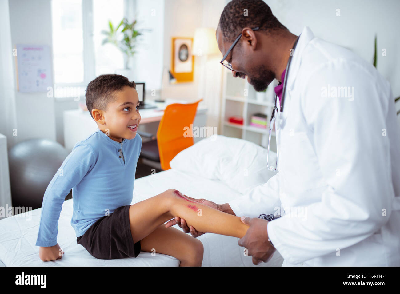 Cute little boy visiting pediatrician after scratching his leg Stock ...