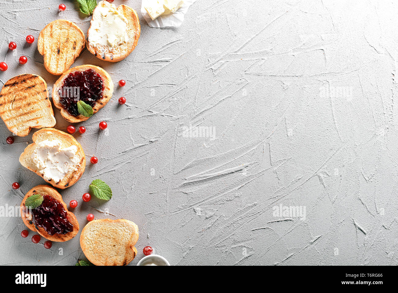 Composition with delicious toasts on light background Stock Photo - Alamy