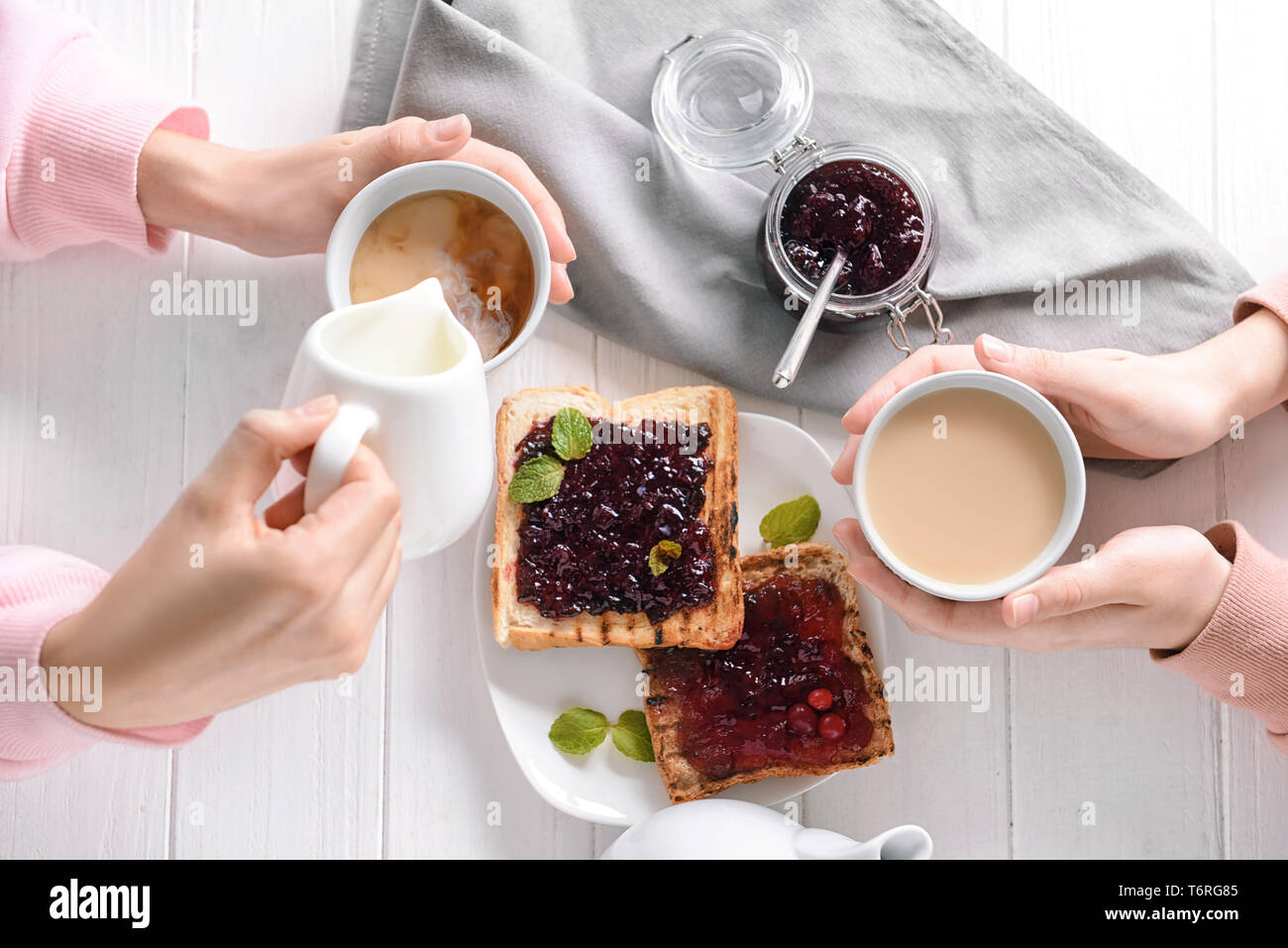 Women drinking tea with milk and delicious toasts, top view Stock Photo ...