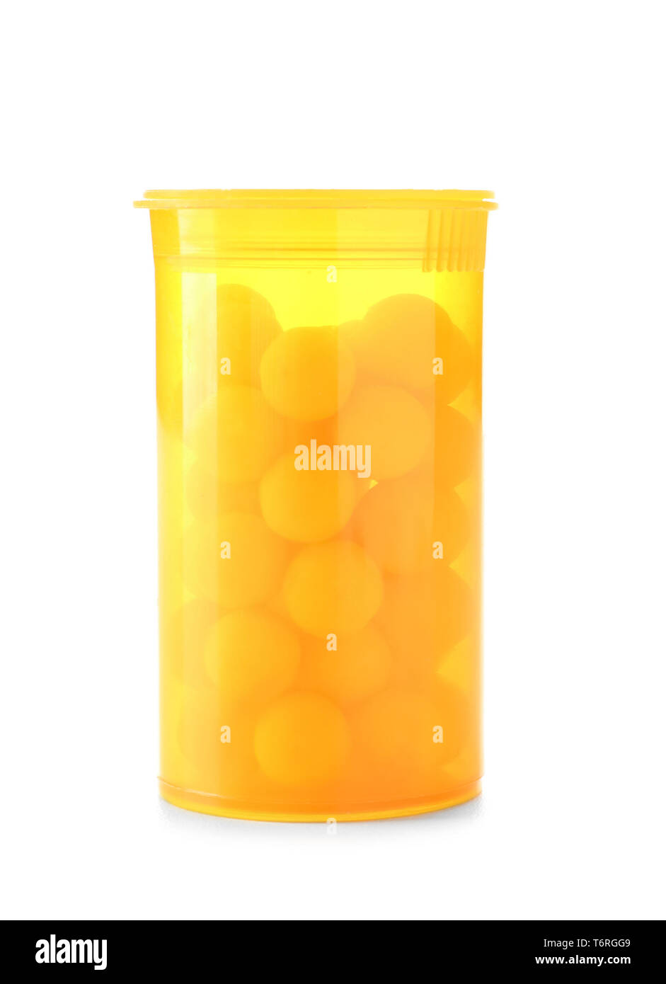 Container with yellow pills on white background Stock Photo - Alamy