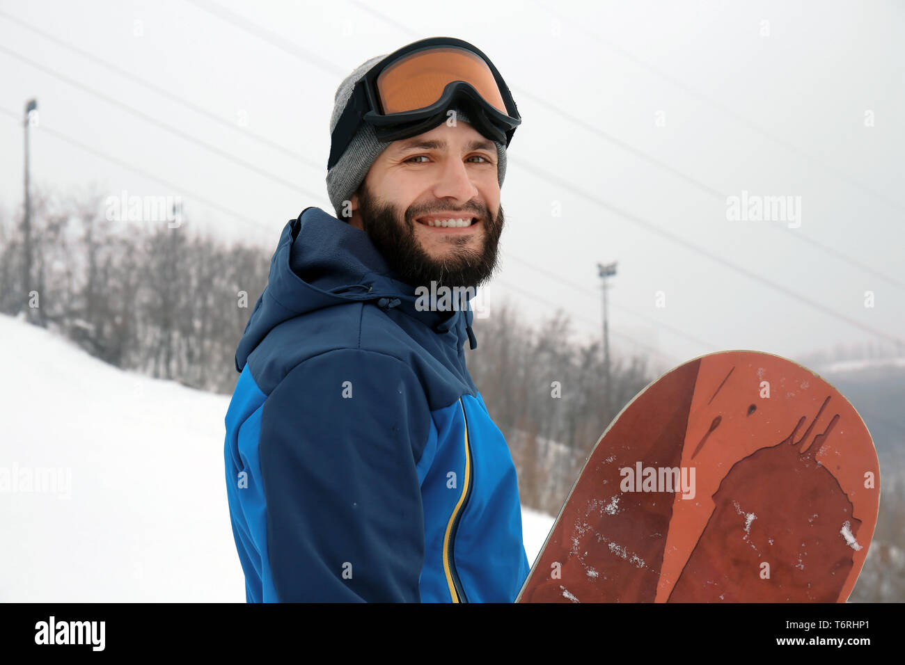 Male snowboarder on slope at winter resort Stock Photo - Alamy
