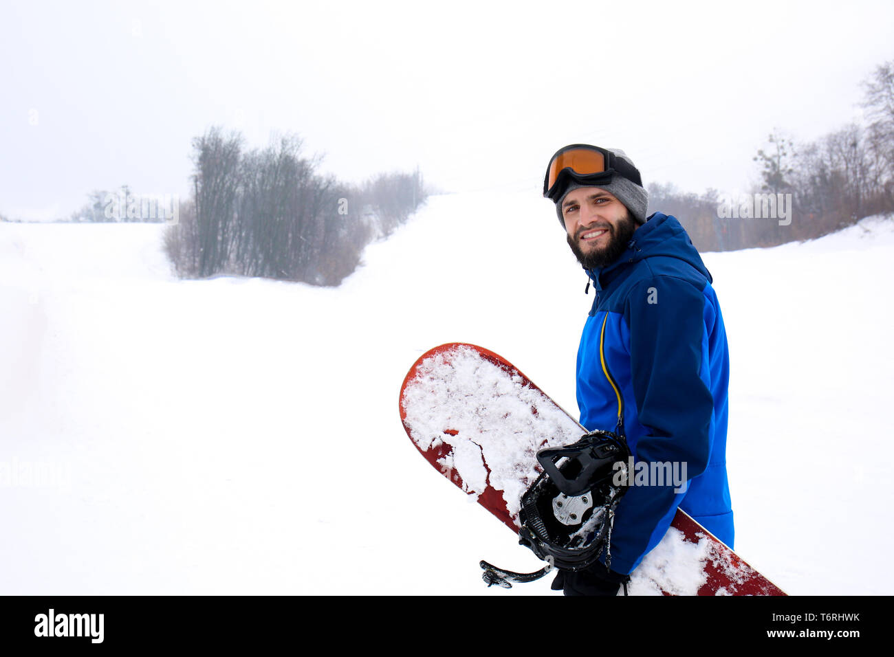 Male snowboarder on slope at winter resort Stock Photo - Alamy