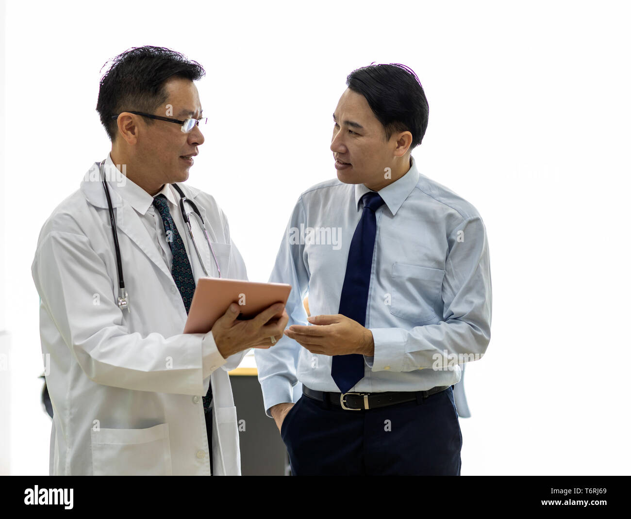 Two men doctor patient using hi-res stock photography and images - Alamy