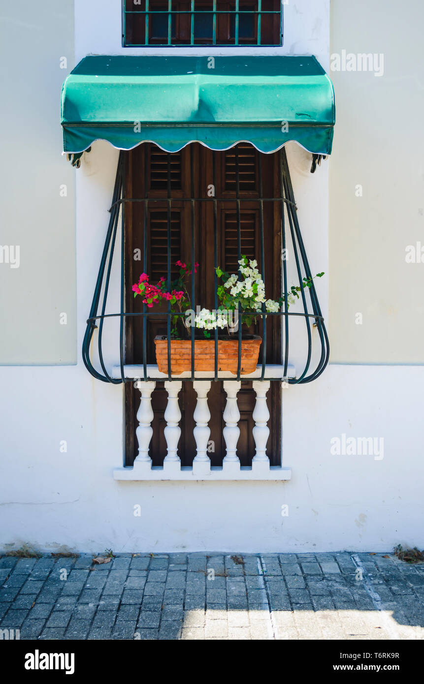 colonial window with iron bars with limestone wall, is typical of the ...