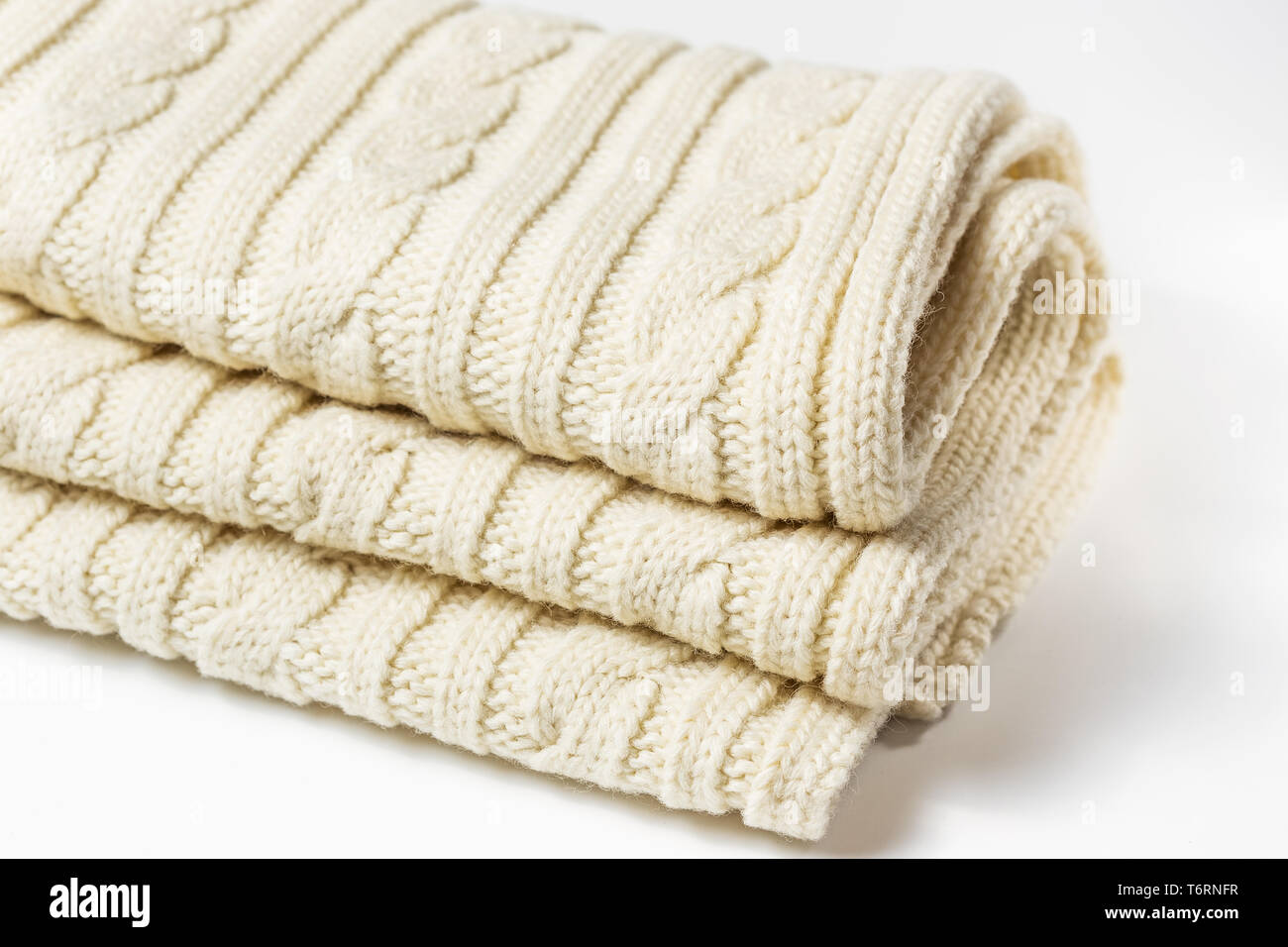 Knitted white scarf with a pattern of braids Stock Photo - Alamy