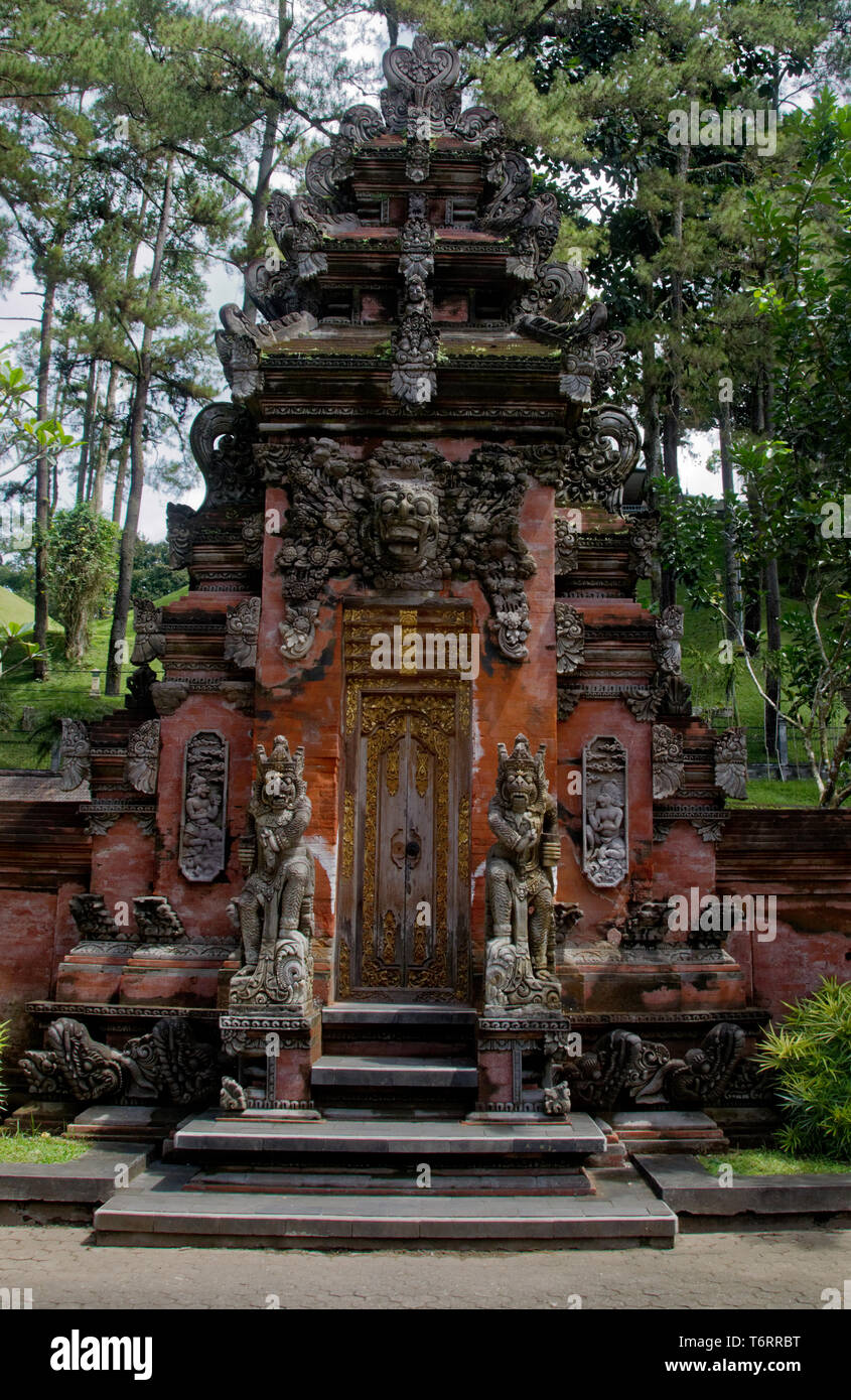 Ornate statues and carvings around an exterior door in the Pura Titra ...