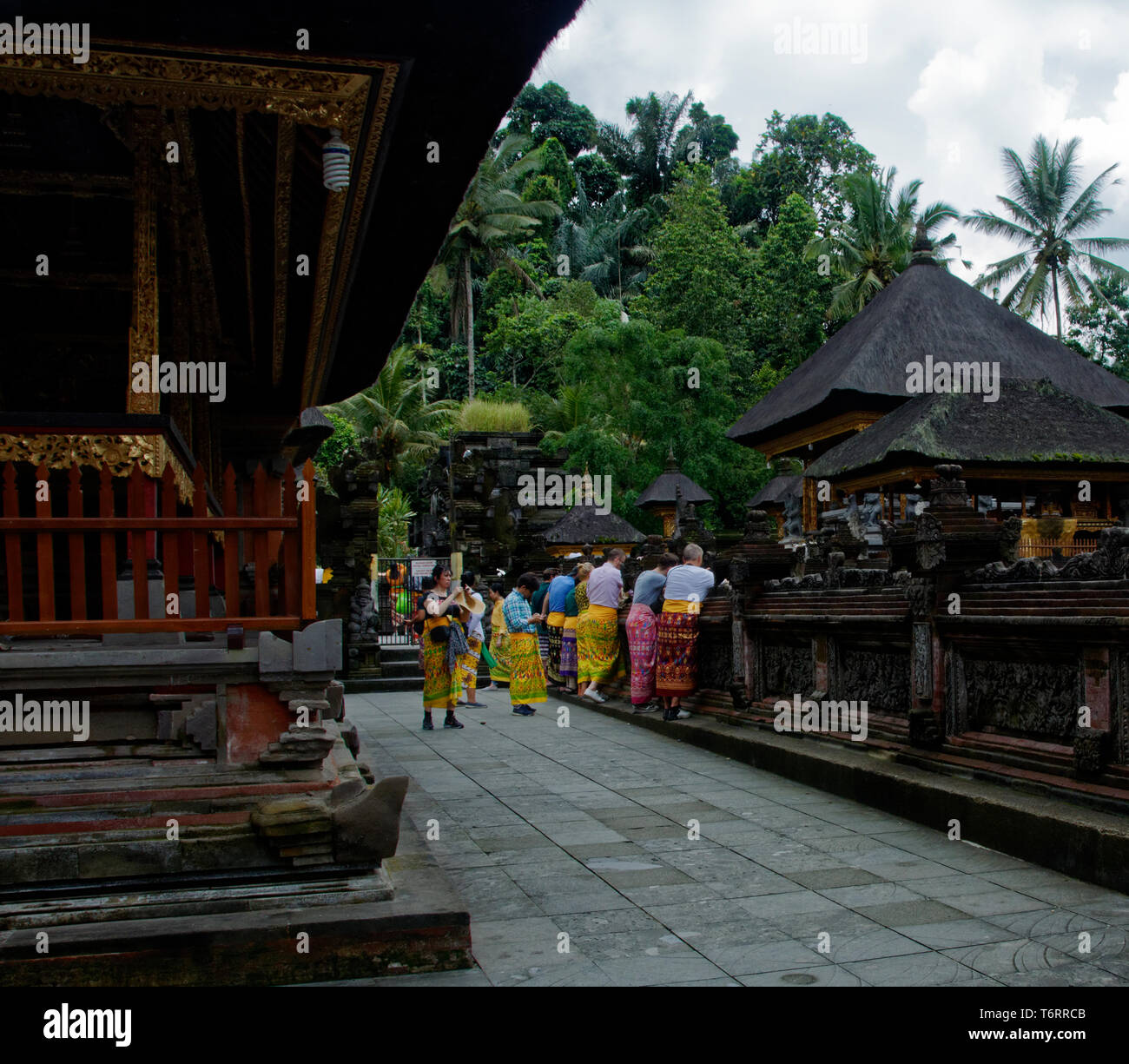Group of tourists in the compulsory sarongs at Pura Tirta Empul, the ...