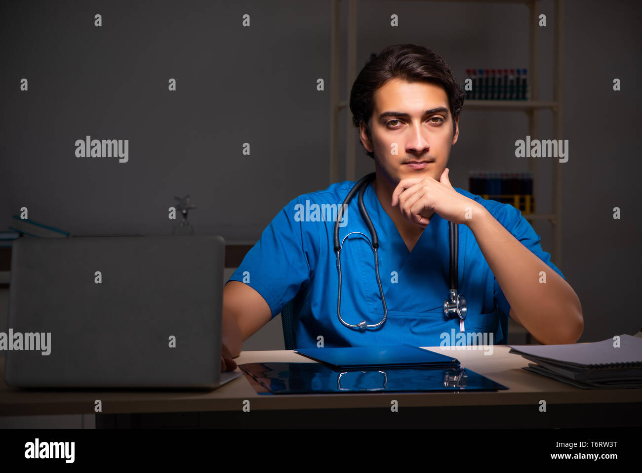 Young handsome doctor working night shift in hospital Stock Photo - Alamy