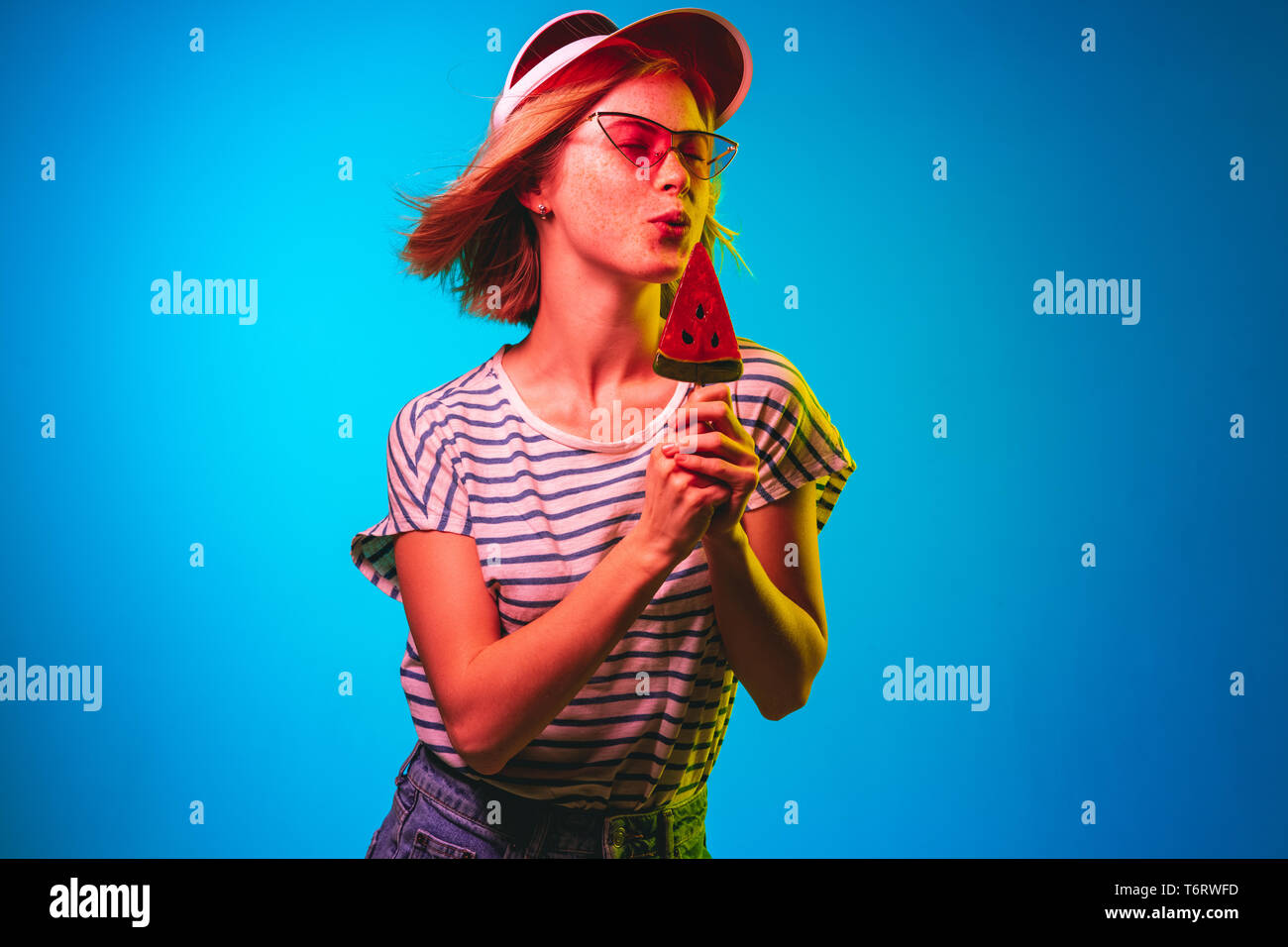 Beautiful female half-length portrait isolated on blue neon lights ...