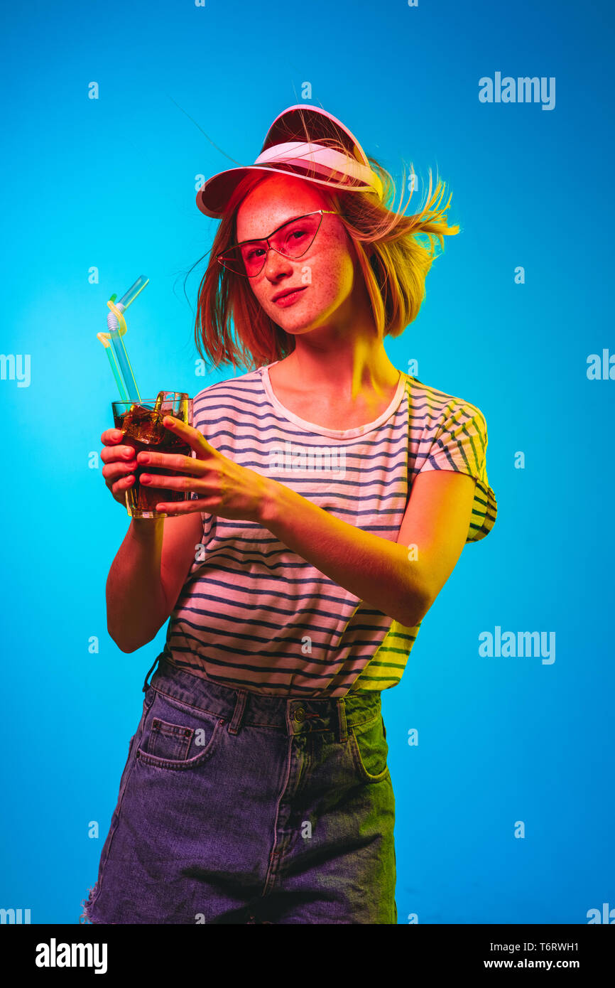 Beautiful female half-length portrait isolated on blue neon lights ...
