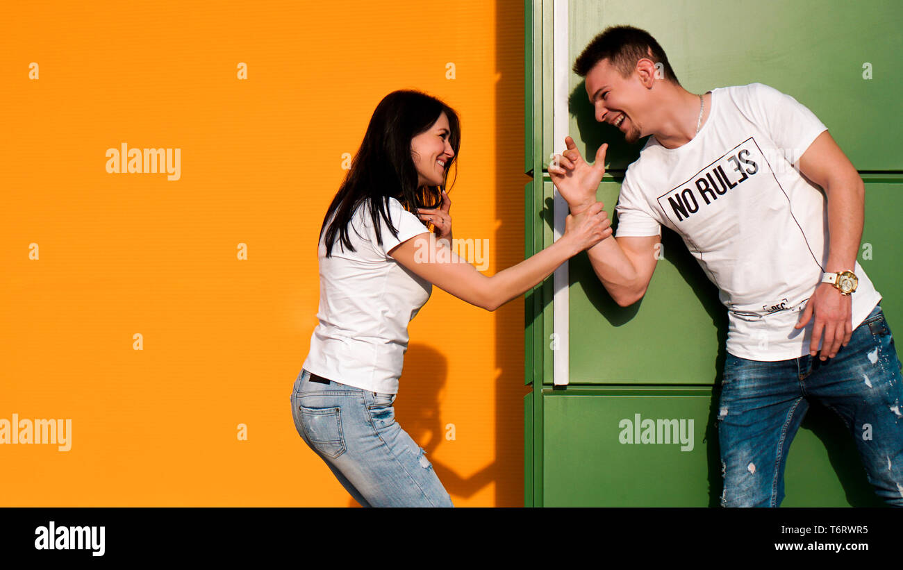 Young couple in love hiding from each other. The girl scared the guy ...