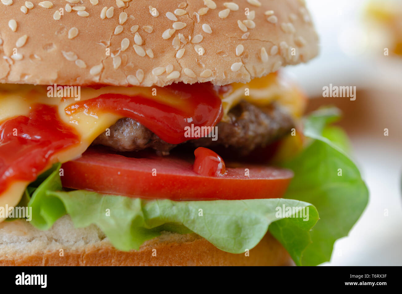 Homemade hamburger with beef, tomato, lettuce and cheese. Fresh burger ...