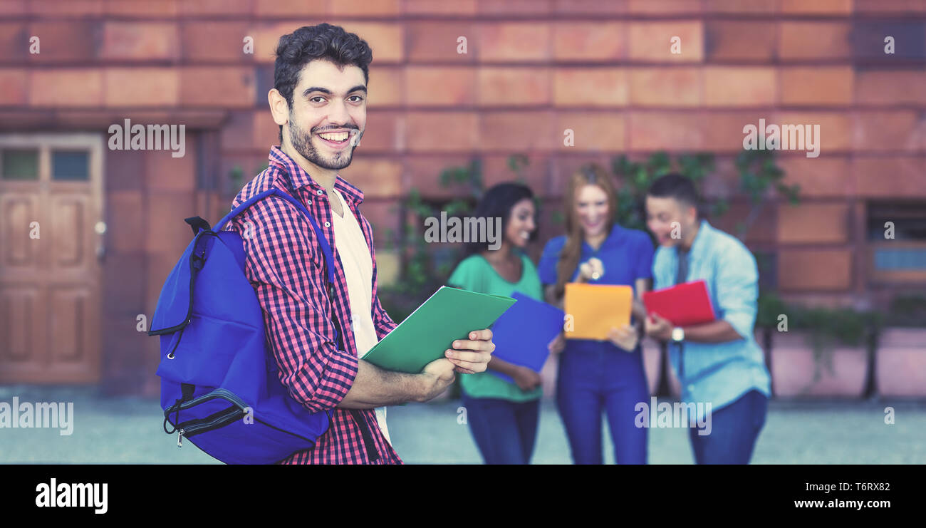 Laughing german male student with group of students outdoor in the ...