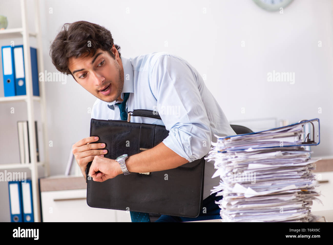 Overloaded busy employee with too much work and paperwork Stock Photo ...