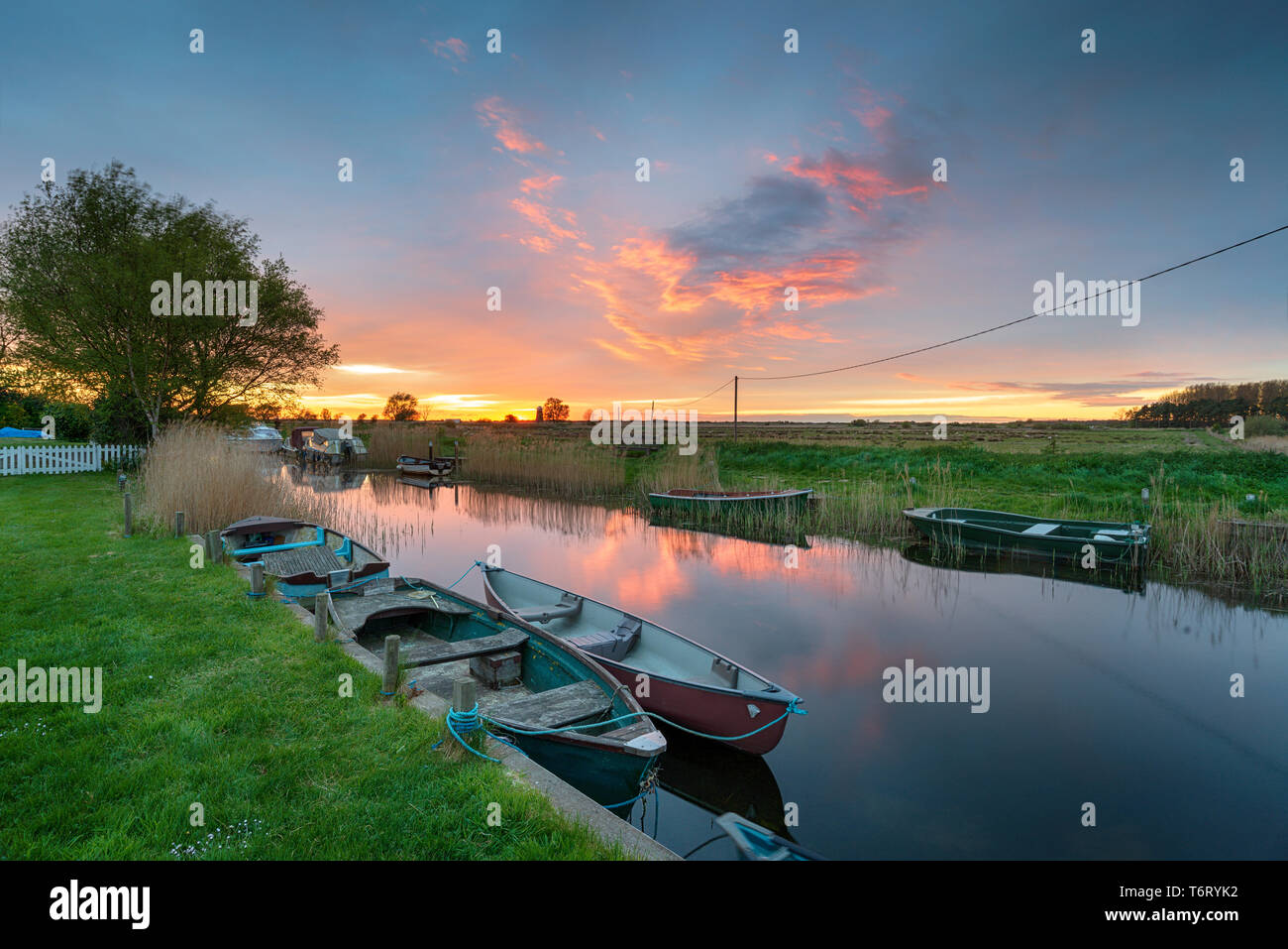 Stunning sunset over boats moored on the river at West Somerton on ...