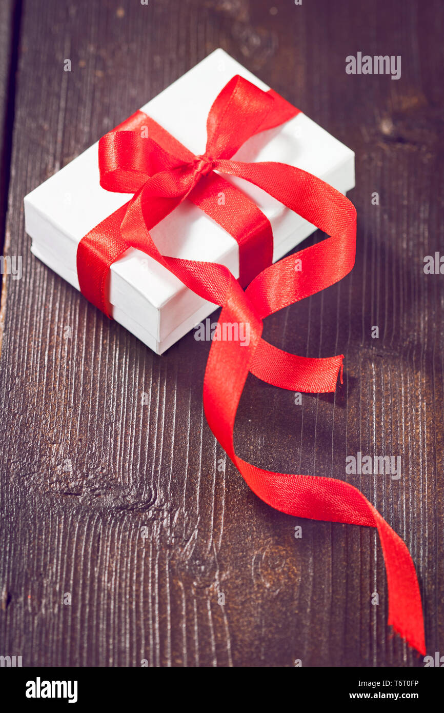 White gift box with red ribbon Stock Photo - Alamy