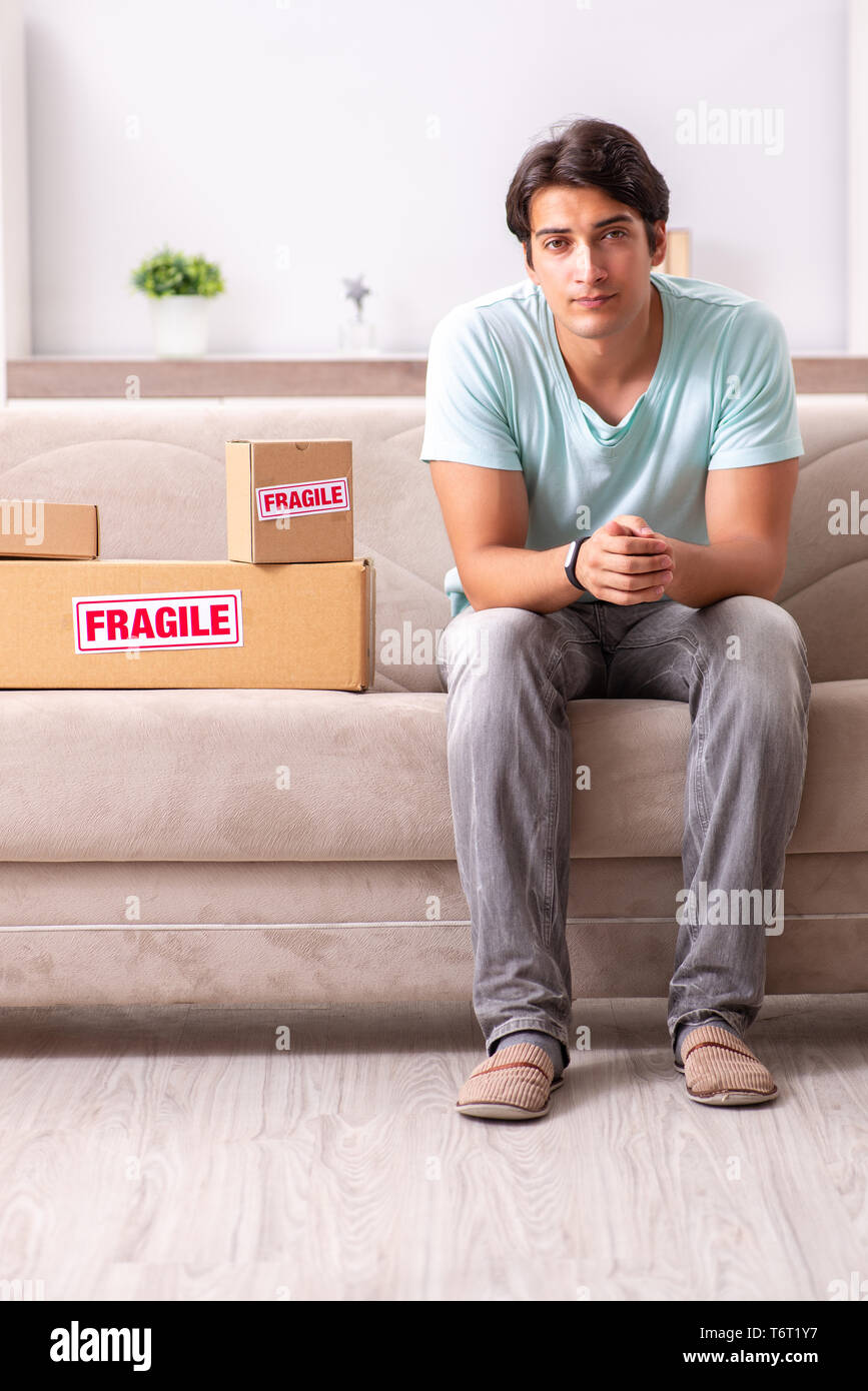 Man opening fragile parcel ordered from internet Stock Photo - Alamy