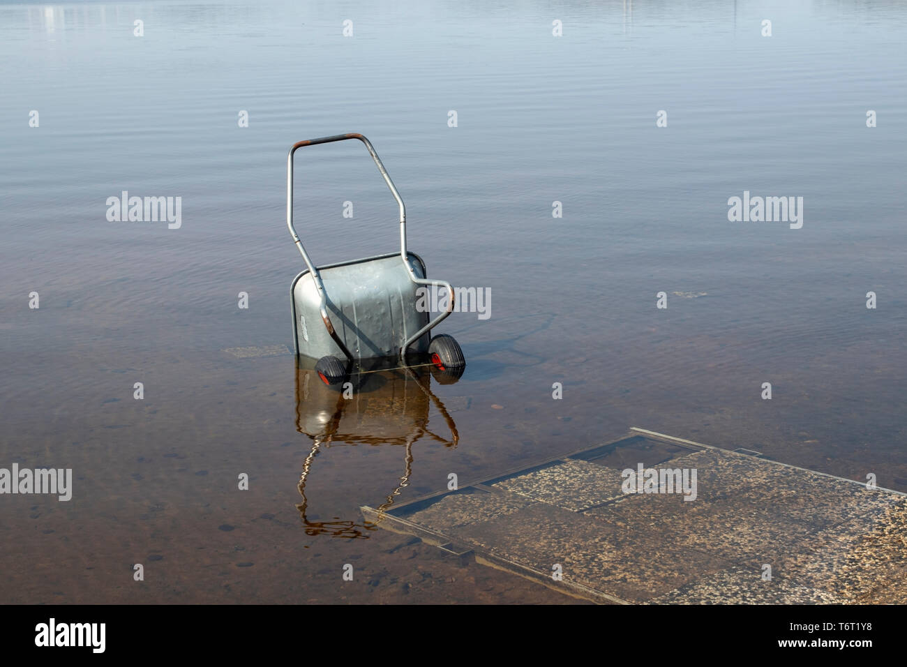 wheelbarrow lying in a lake, Finland Stock Photo - Alamy