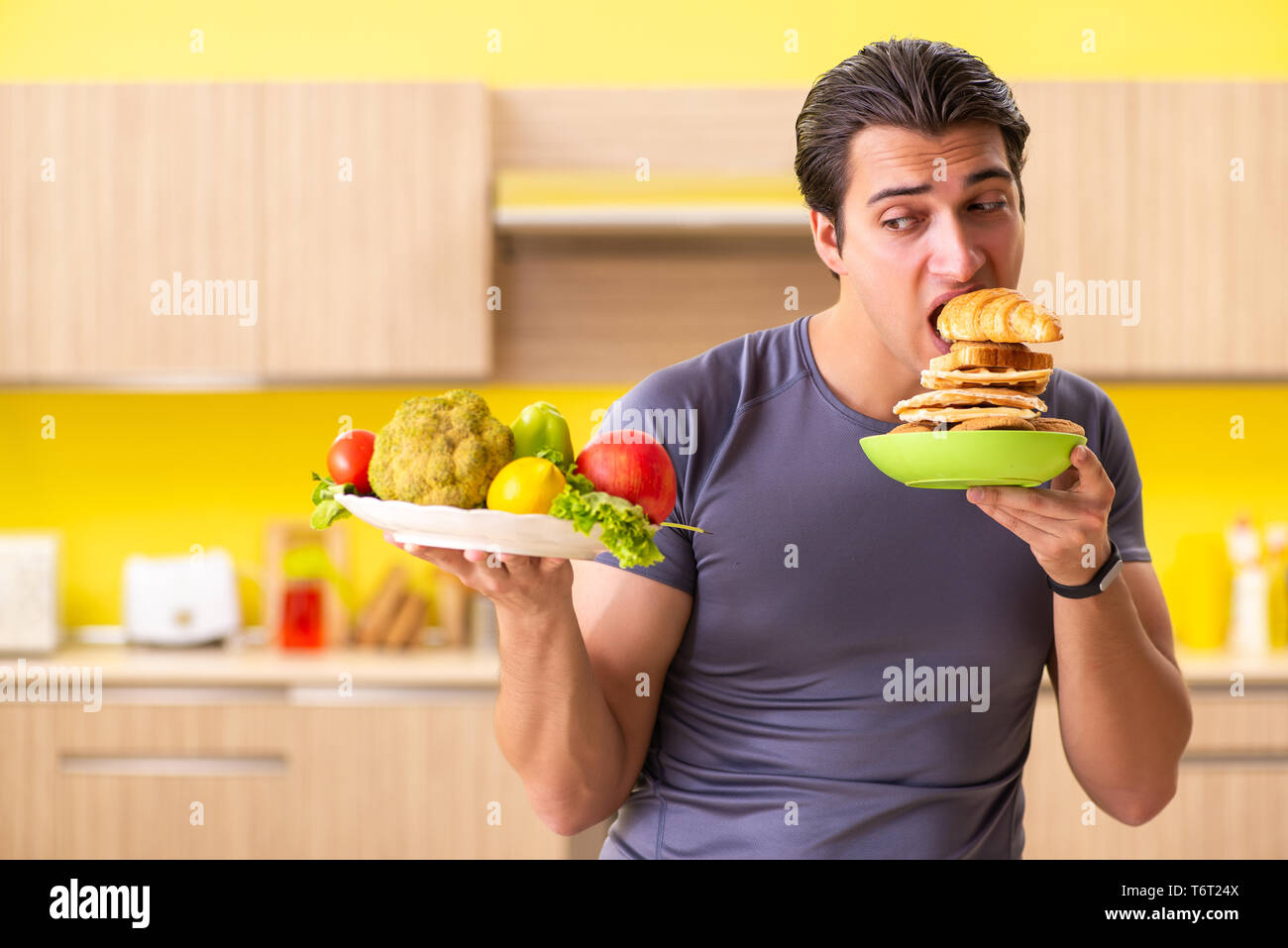 Man having hard choice between healthy and unhealthy food Stock Photo ...