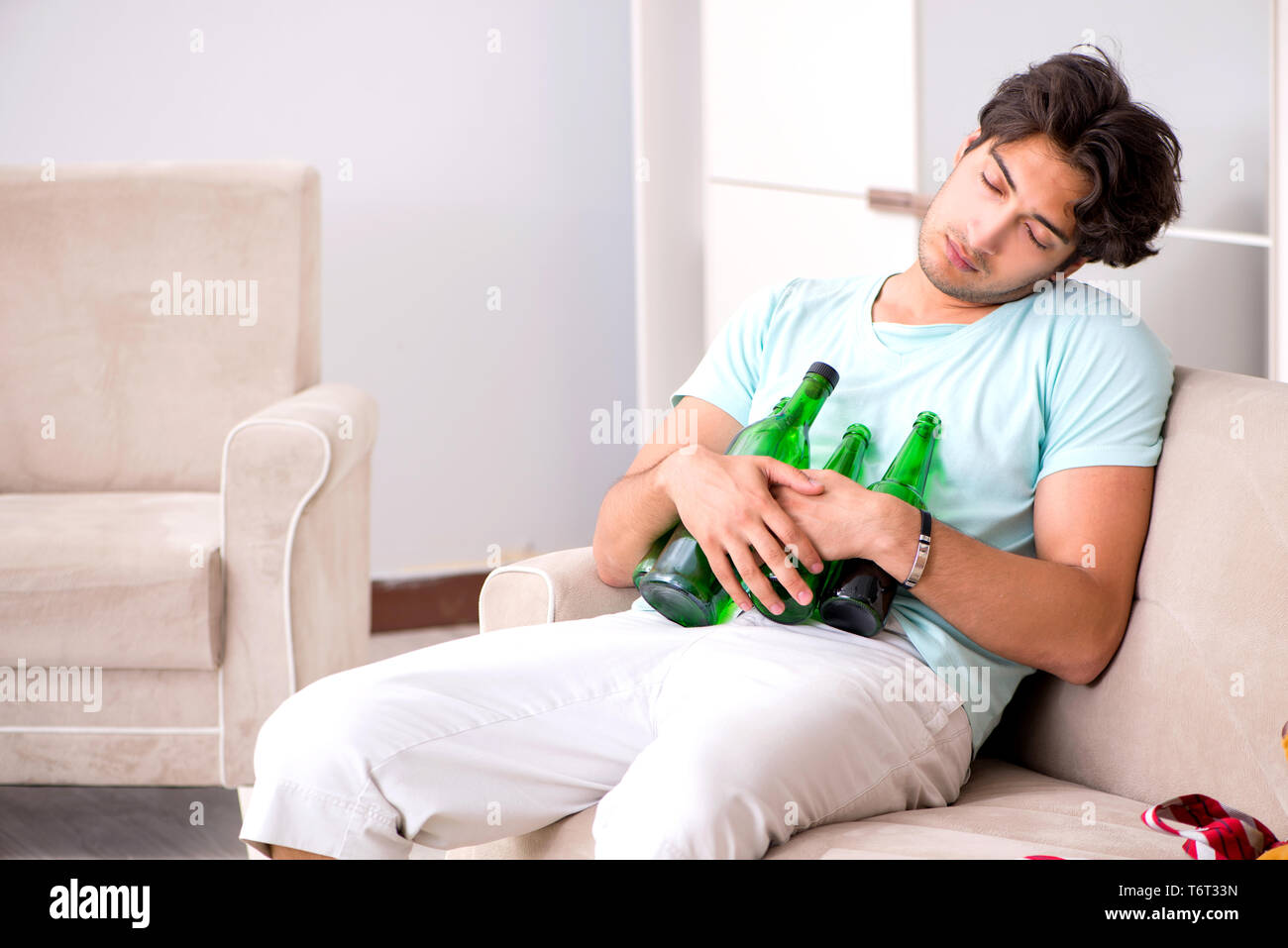 Young drunk handsome man after party at home Stock Photo - Alamy