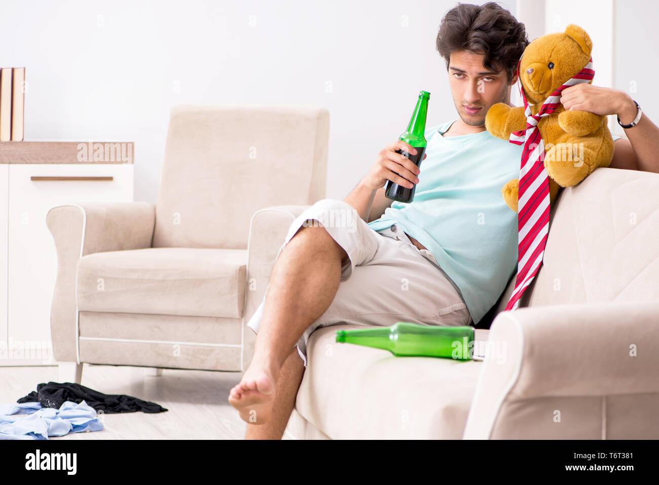 Young drunk handsome man after party at home Stock Photo - Alamy