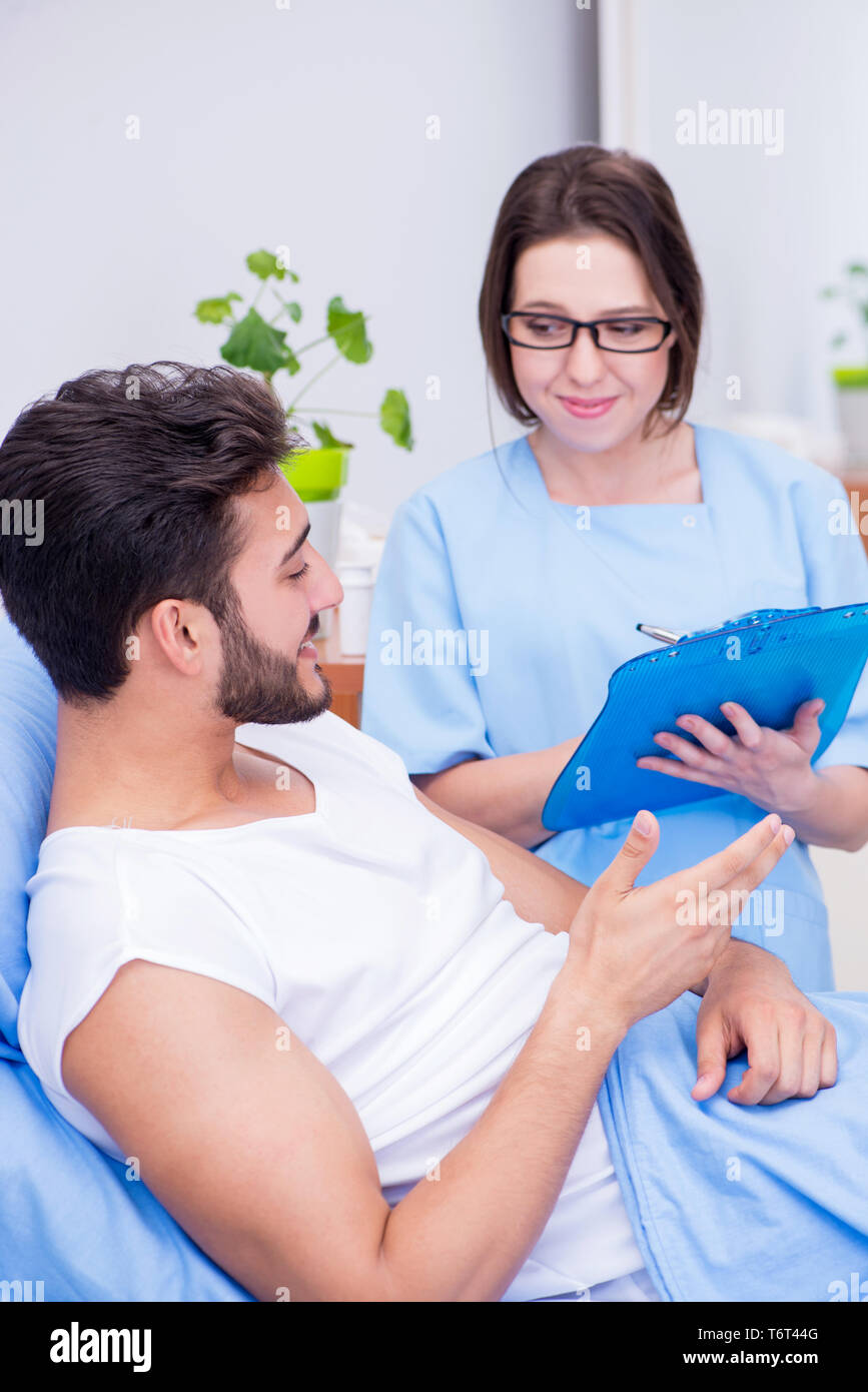 Woman doctor examining male patient in hospital Stock Photo - Alamy