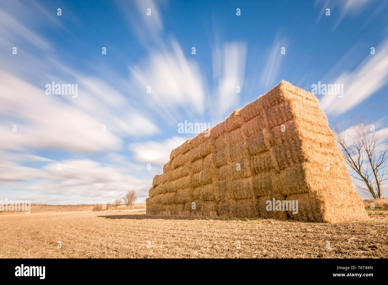Clouds move over fields and straw bales Stock Photo - Alamy