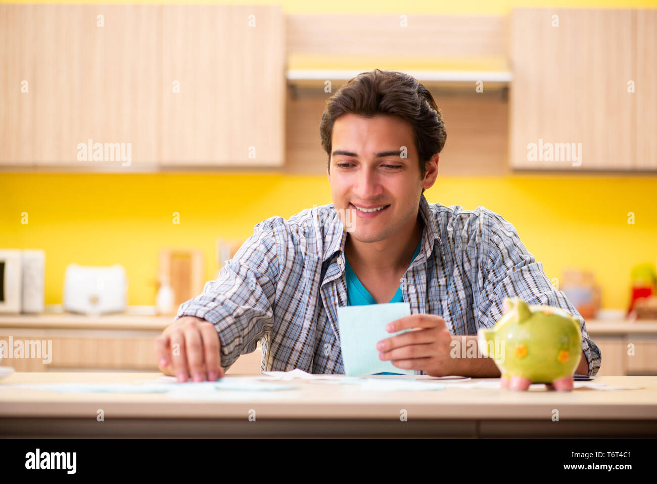 Young man husband in budget planning concept Stock Photo - Alamy