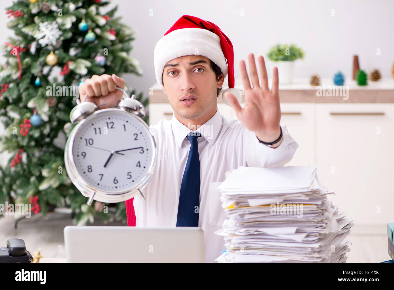 Young worker working in office on christmas shift Stock Photo - Alamy