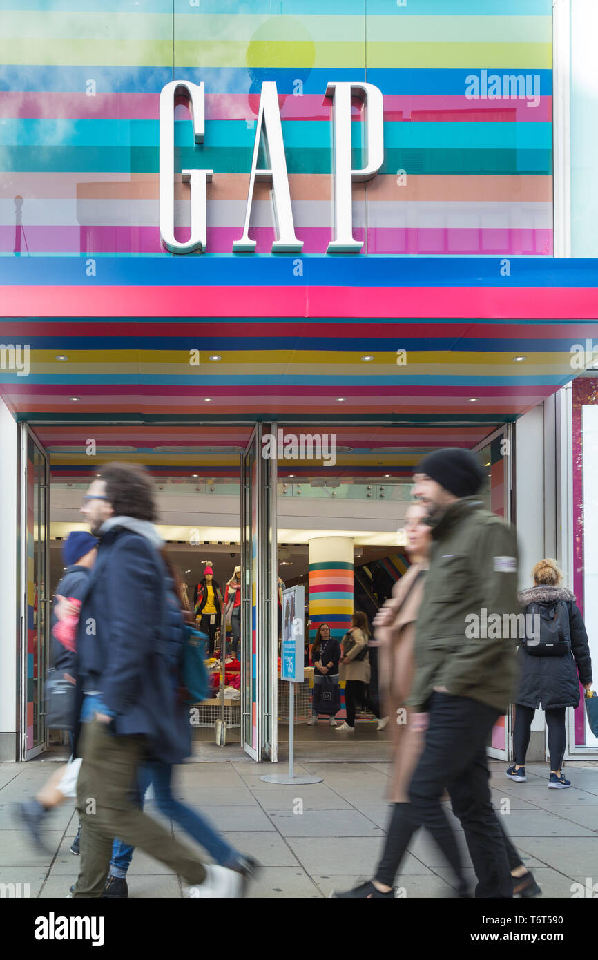Shoppers on Oxford Street in the West End of London walk past a branch ...