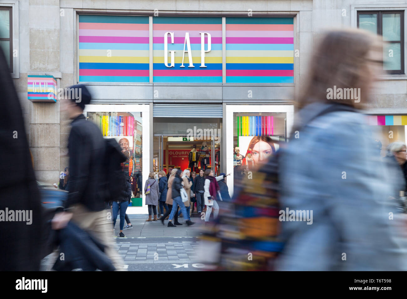 Shoppers on Oxford Street in the West End of London walk past a branch ...
