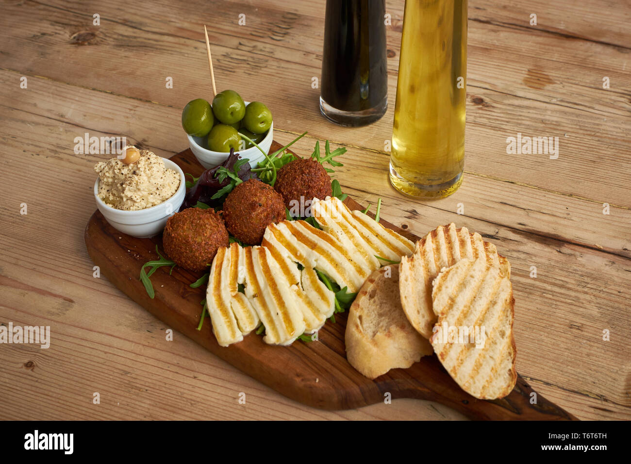Falafel and Halloumi platter on wood table Stock Photo - Alamy