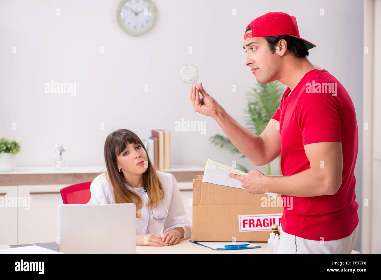 Courier delivering urgent parcel to the hospital Stock Photo - Alamy