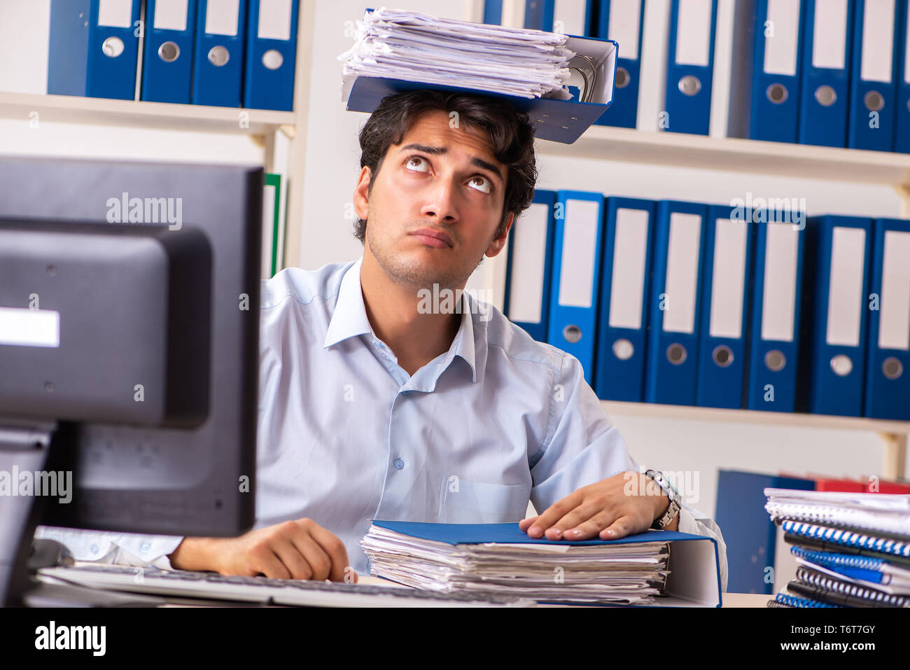 Overloaded busy employee with too much work and paperwork Stock Photo ...