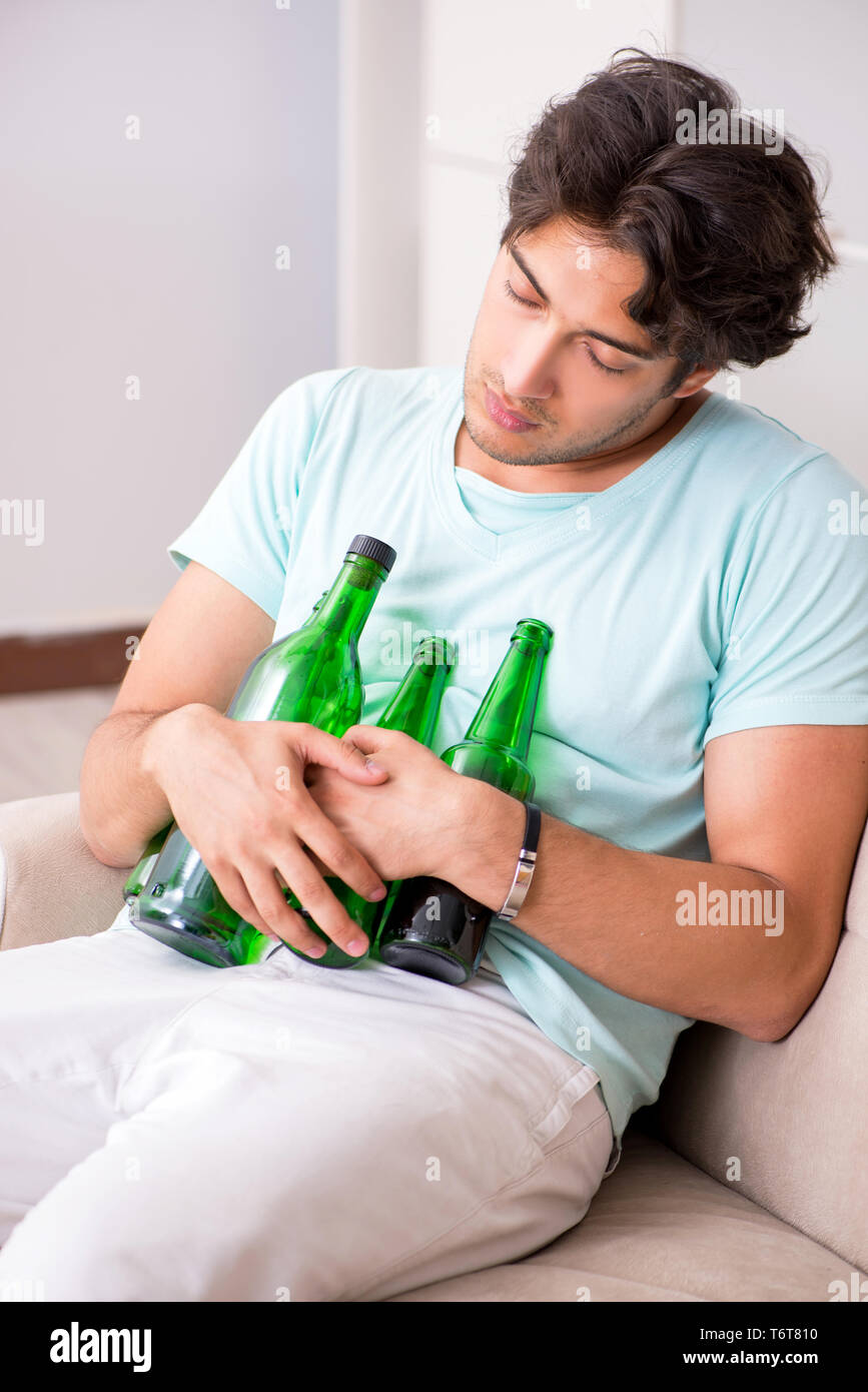 Young drunk handsome man after party at home Stock Photo - Alamy