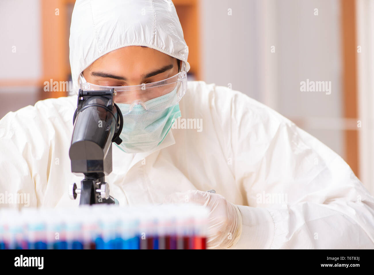 Young biochemist wearing protective suit working in the lab Stock Photo ...
