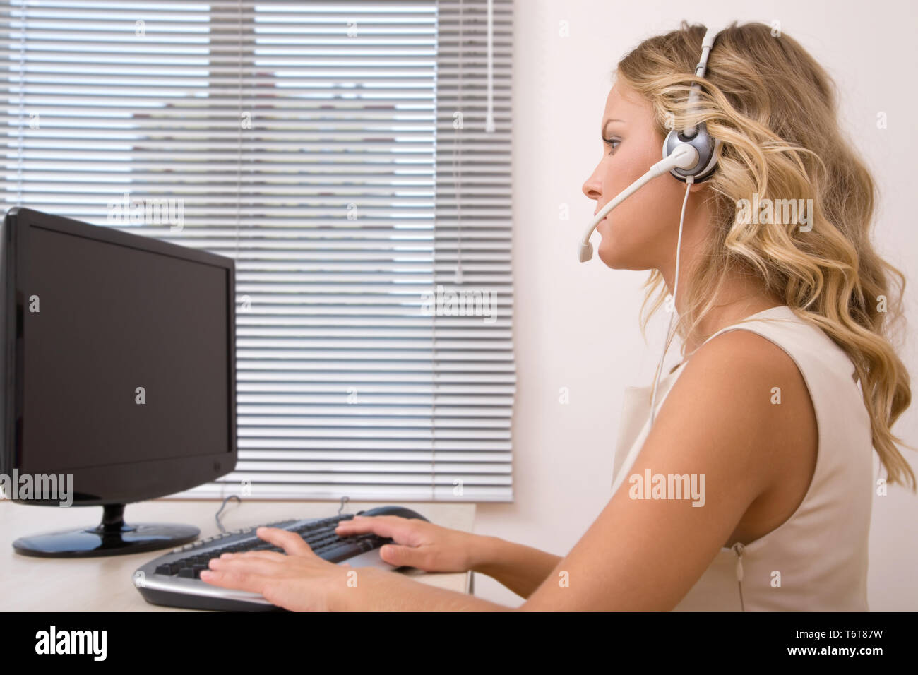 customer service representative at the office with computer Stock Photo ...