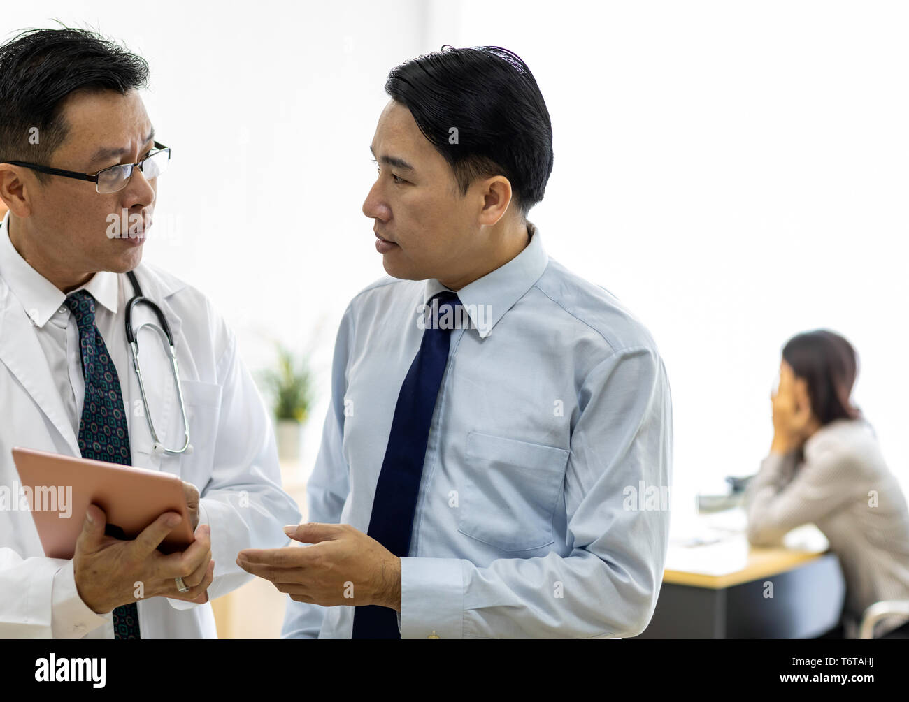 Two men doctor patient using hi-res stock photography and images - Alamy